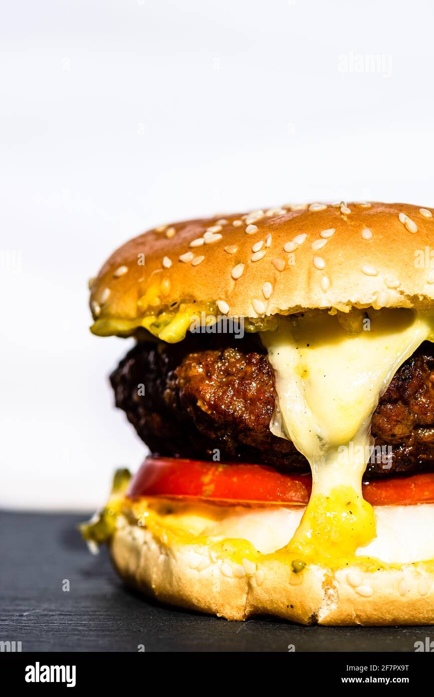 Beef cheeseburger with melting cheese. Tasty homemade cheeseburger ...