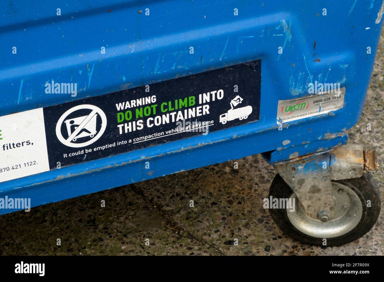 Warning on a waste dumper bin, do not climb in Stock Photo - Alamy