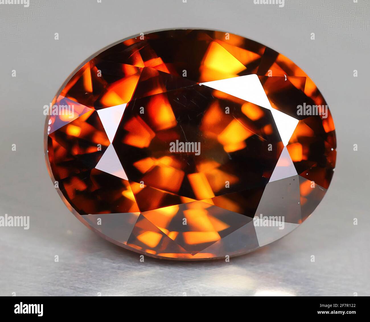 Natural gemstone red zircon on gray background Stock Photo - Alamy