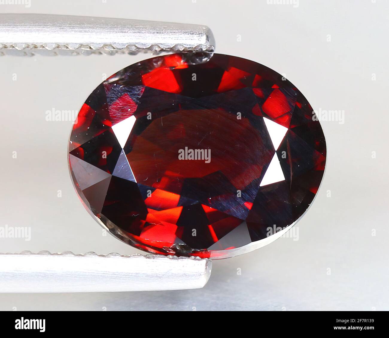 Natural gemstone red zircon on gray background Stock Photo - Alamy
