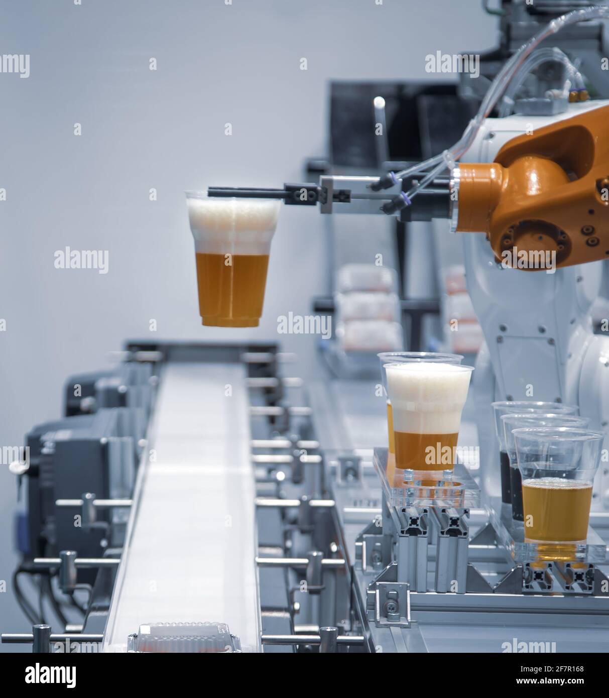 Robotic arm pouring and serving a glass of beer on belt conveyor Stock ...