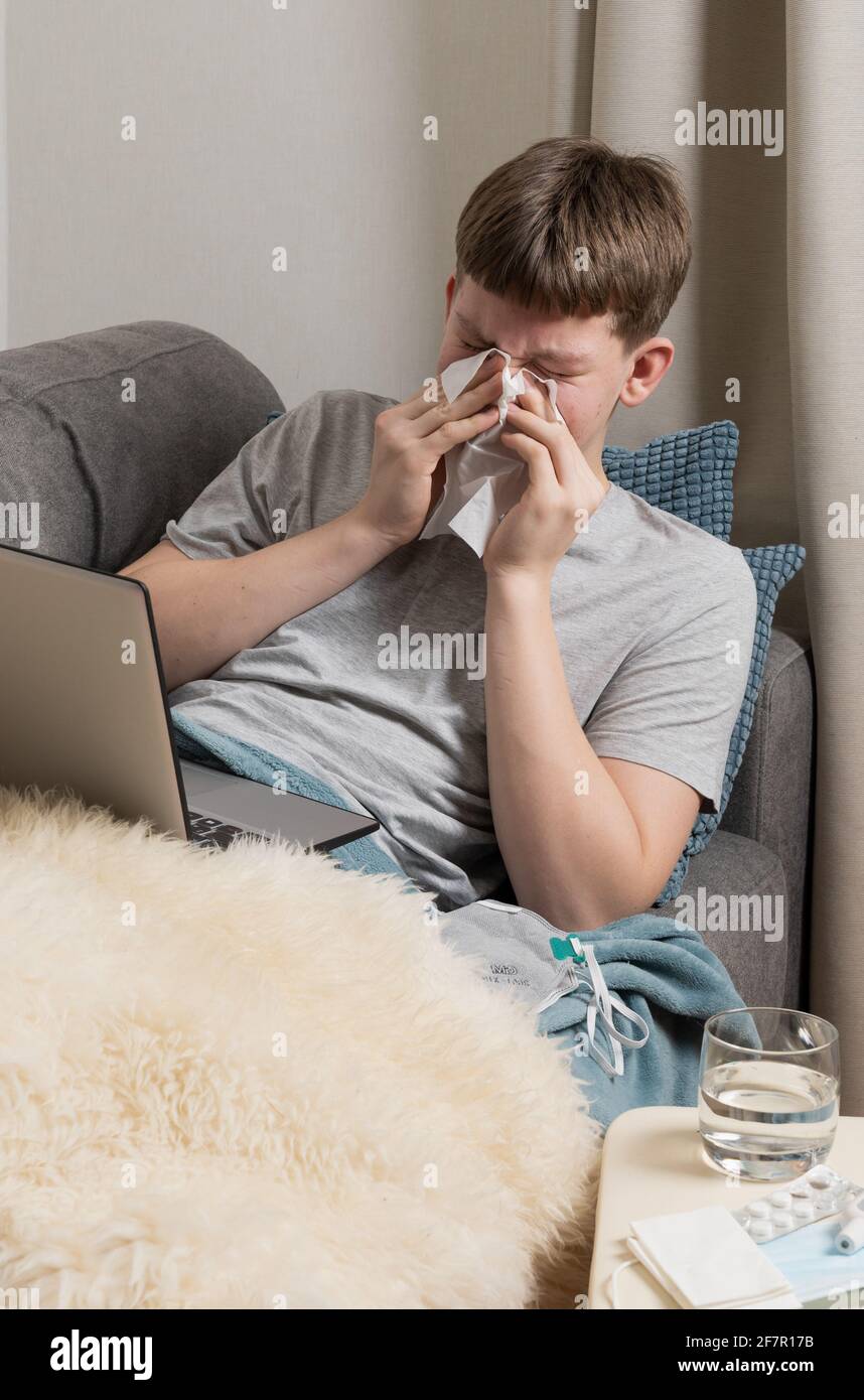 Teenager tries to study online and sneezes into paper towel. Self ...