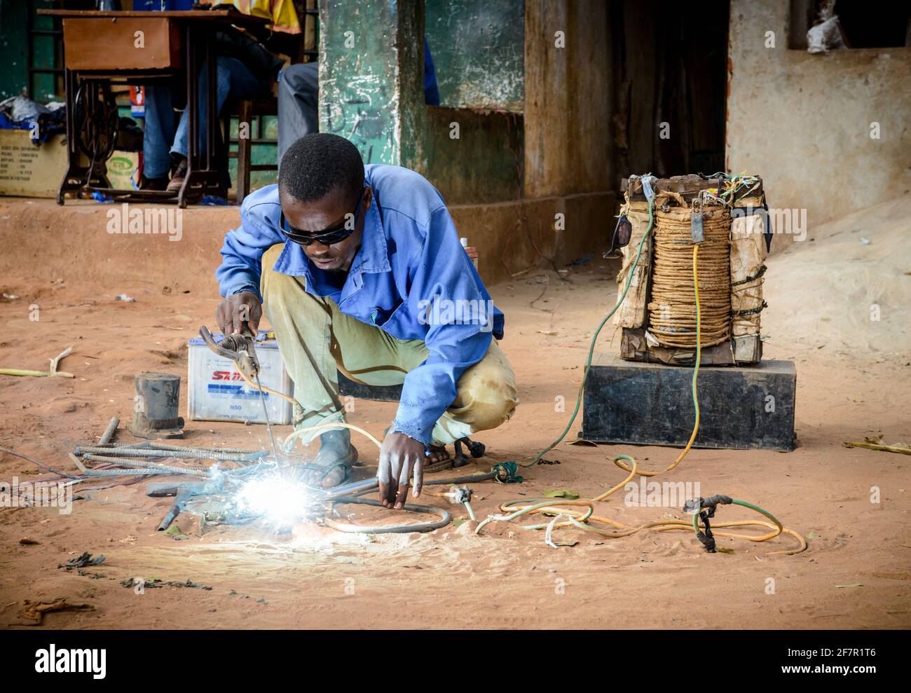 Man in street scene in Malawi village with crude welding set Stock ...