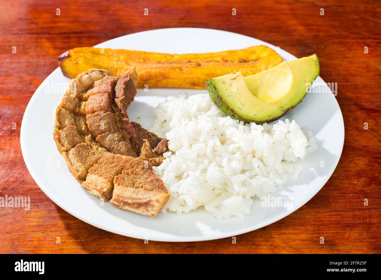 Pork rind, rice, fried banana and avocado - Typical Colombian dish ...