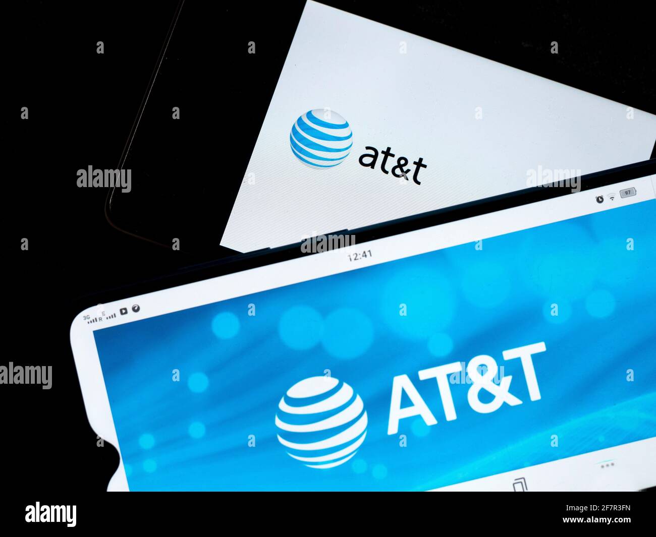In this photo illustration, AT&T logos seen displayed on smartphones Stock Photo - Alamy