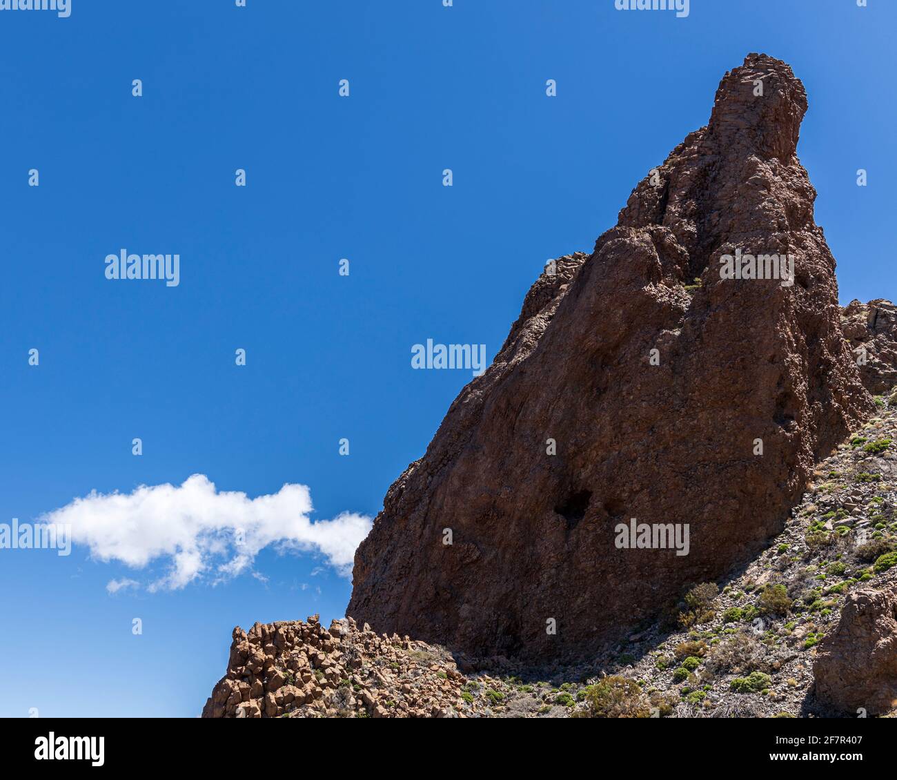 Pinnacle shaped rock formation and small cloud in the Las Canadas del ...