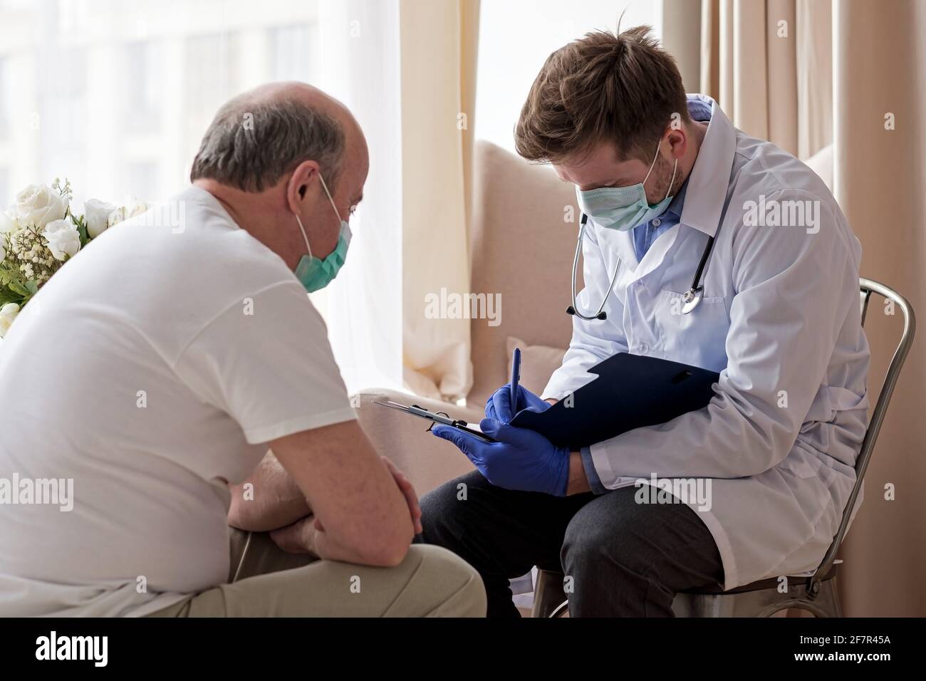 Old man visiting doctor hi-res stock photography and images - Alamy