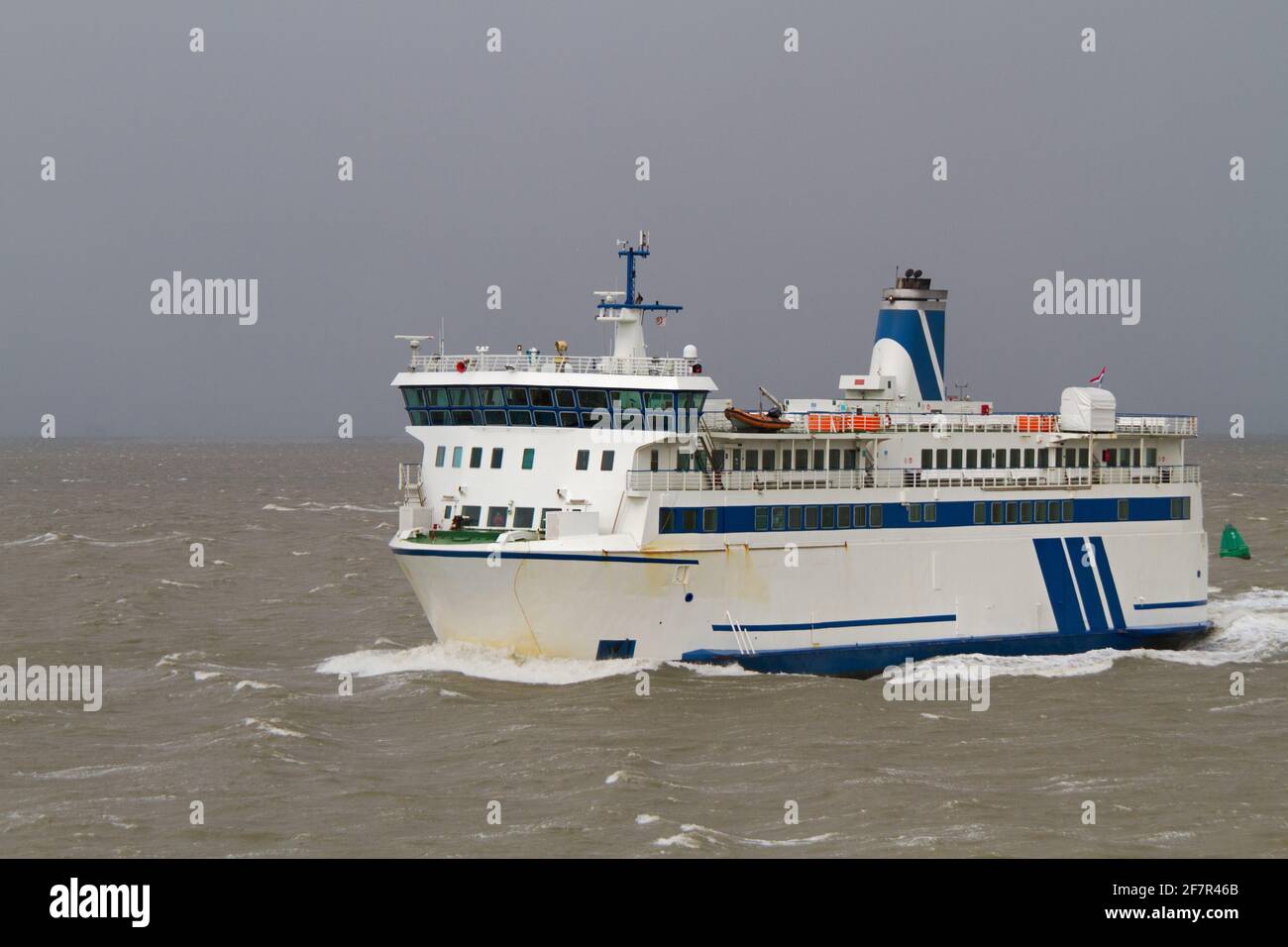 White and blue ferry boat on the grey Dutch Waddenzee Stock Photo - Alamy