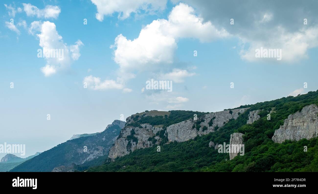 A view of the rocky peaks covered with dense forest from one of the ...