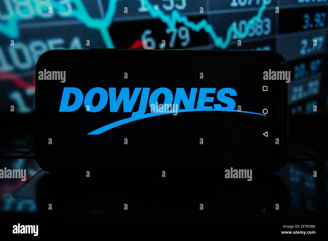 In this photo illustration a DowJones logo seen displayed on a ...
