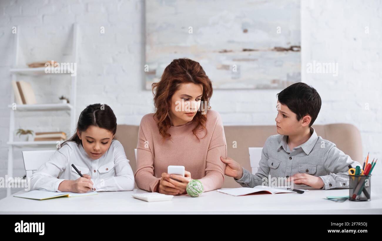 Girl helping brother homework hi-res stock photography and images - Alamy