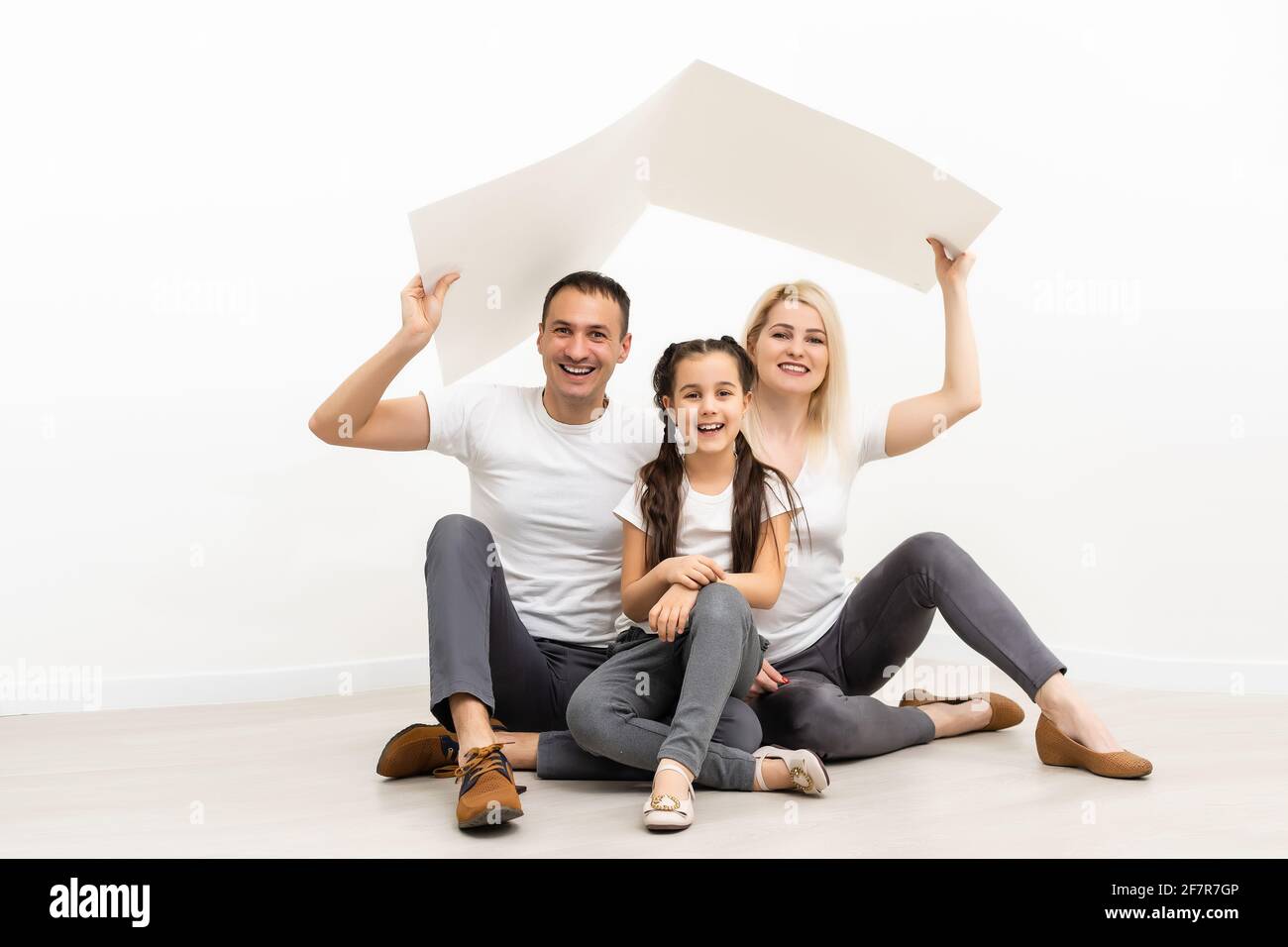 concept housing a young family. Mother father and child in new house ...