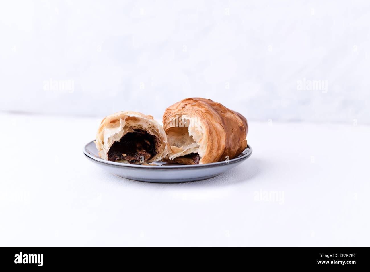 Croissant on bright wooden background. Copy space Stock Photo - Alamy