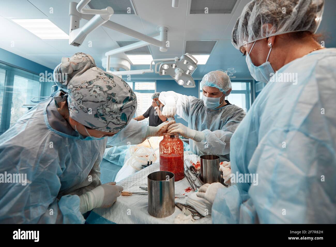 cosmetic liposuction surgery in actual operating room setting showing ...