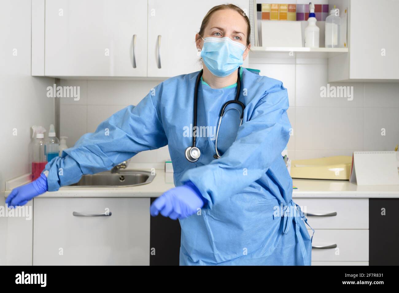 Positive female doctor dancing floss dance in hospital, celebrating the ...
