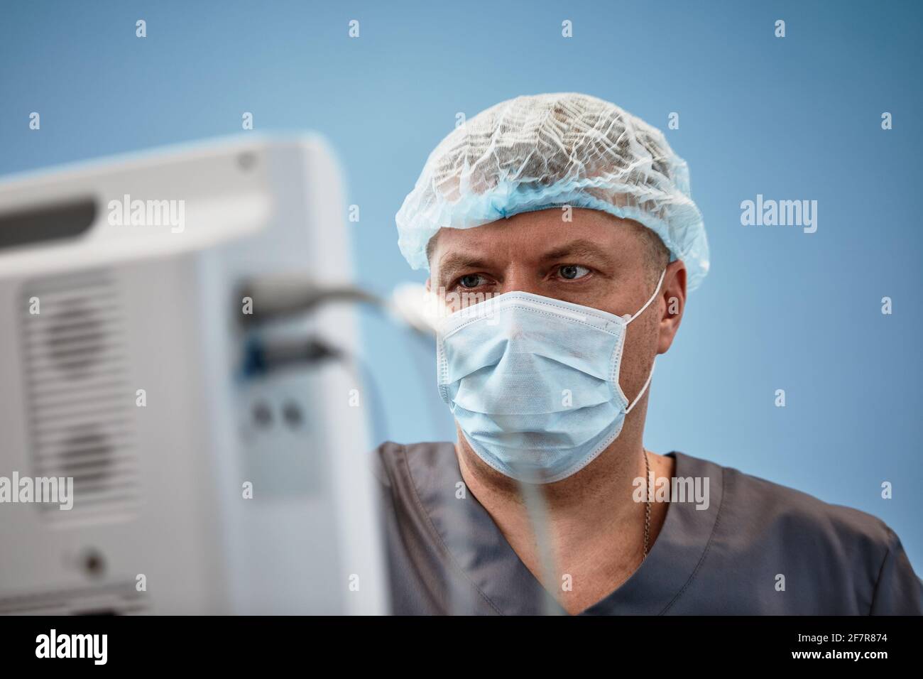 Anesthesiologist keeping track of vital functions of the body during ...