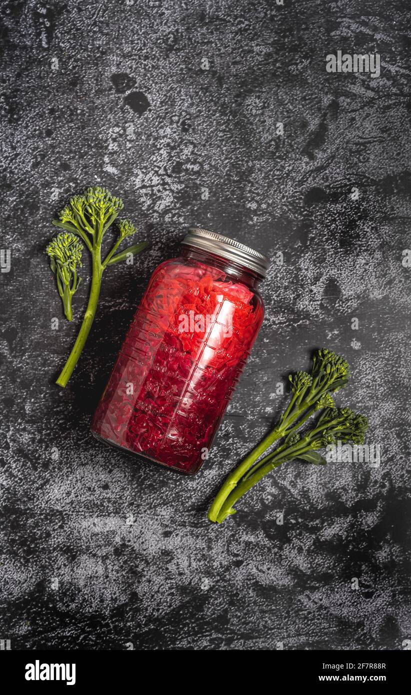 Top view dark moody food photography of a jar with homemade fermented ...