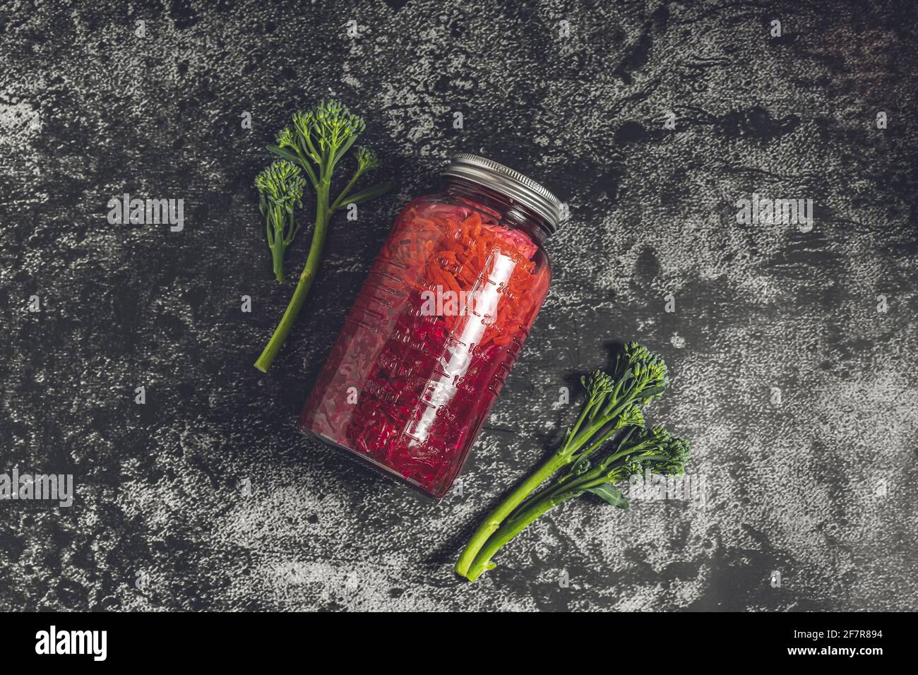 Flat lay dark moody food photography of a jar with homemade fermented ...