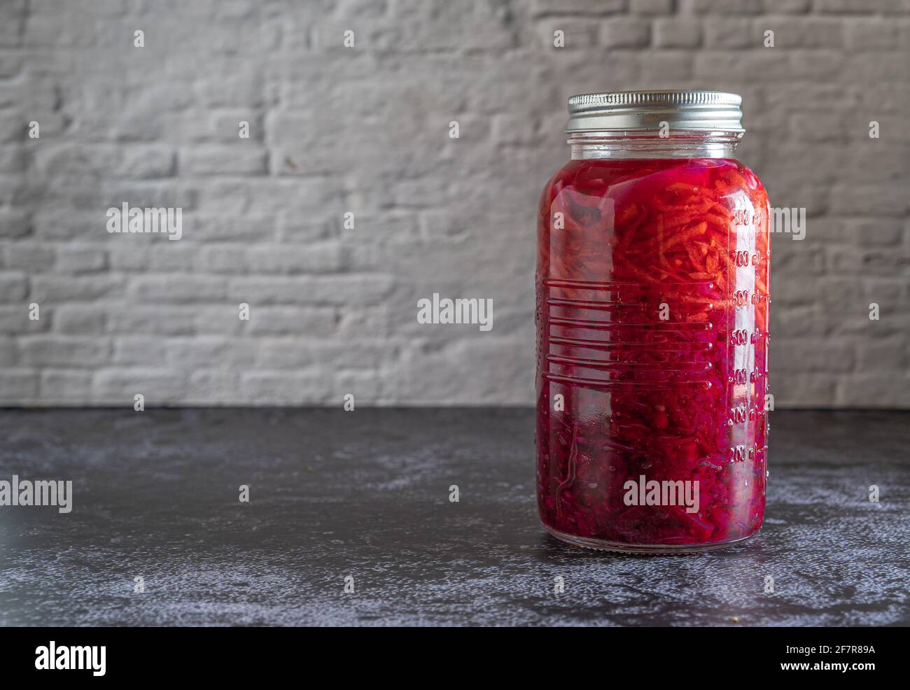 Dark moody food photography of a jar with homemade fermented red ...