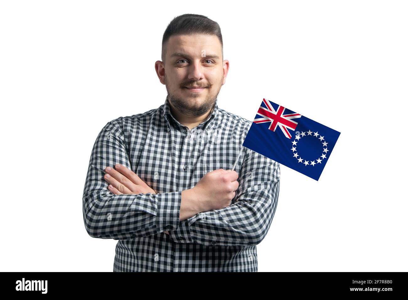 White guy holding a flag of Cook Islands smiling confident with crossed ...