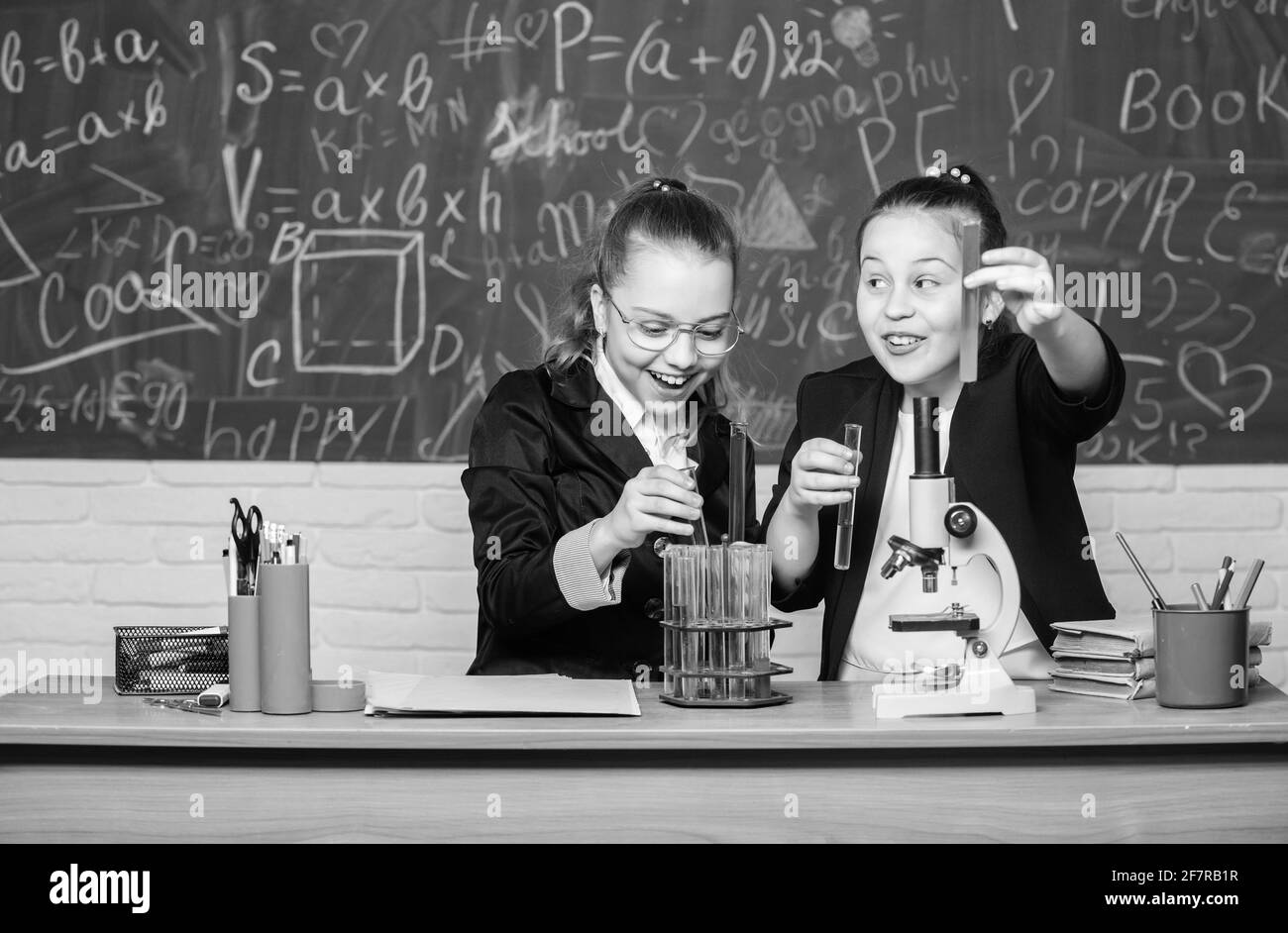 travel the world with science. Little girls genius in school lab ...
