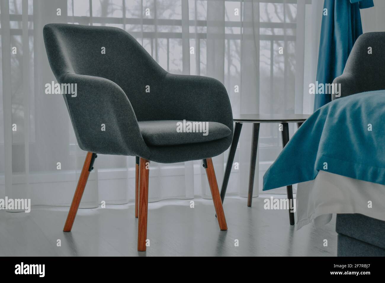 Two chairs with a small table in a bedroom interior Stock Photo - Alamy
