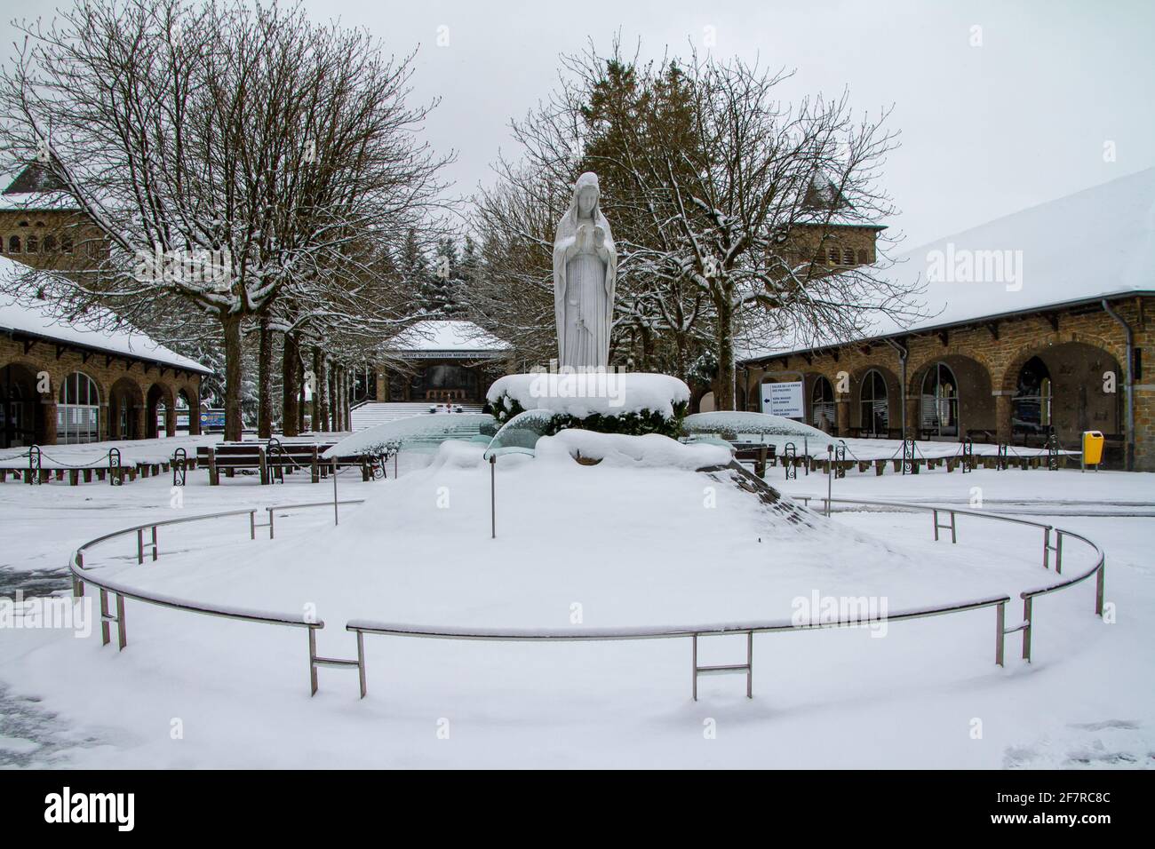 Banneux, Belgium, Statue of the Virgin Mary under the snow. Banneux is ...