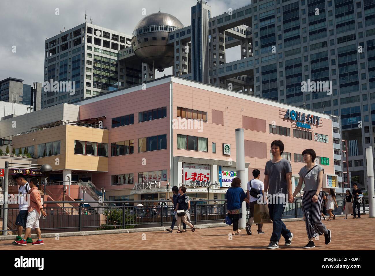 Horizontal view of people strolling in Minato City with the Fuji TV ...