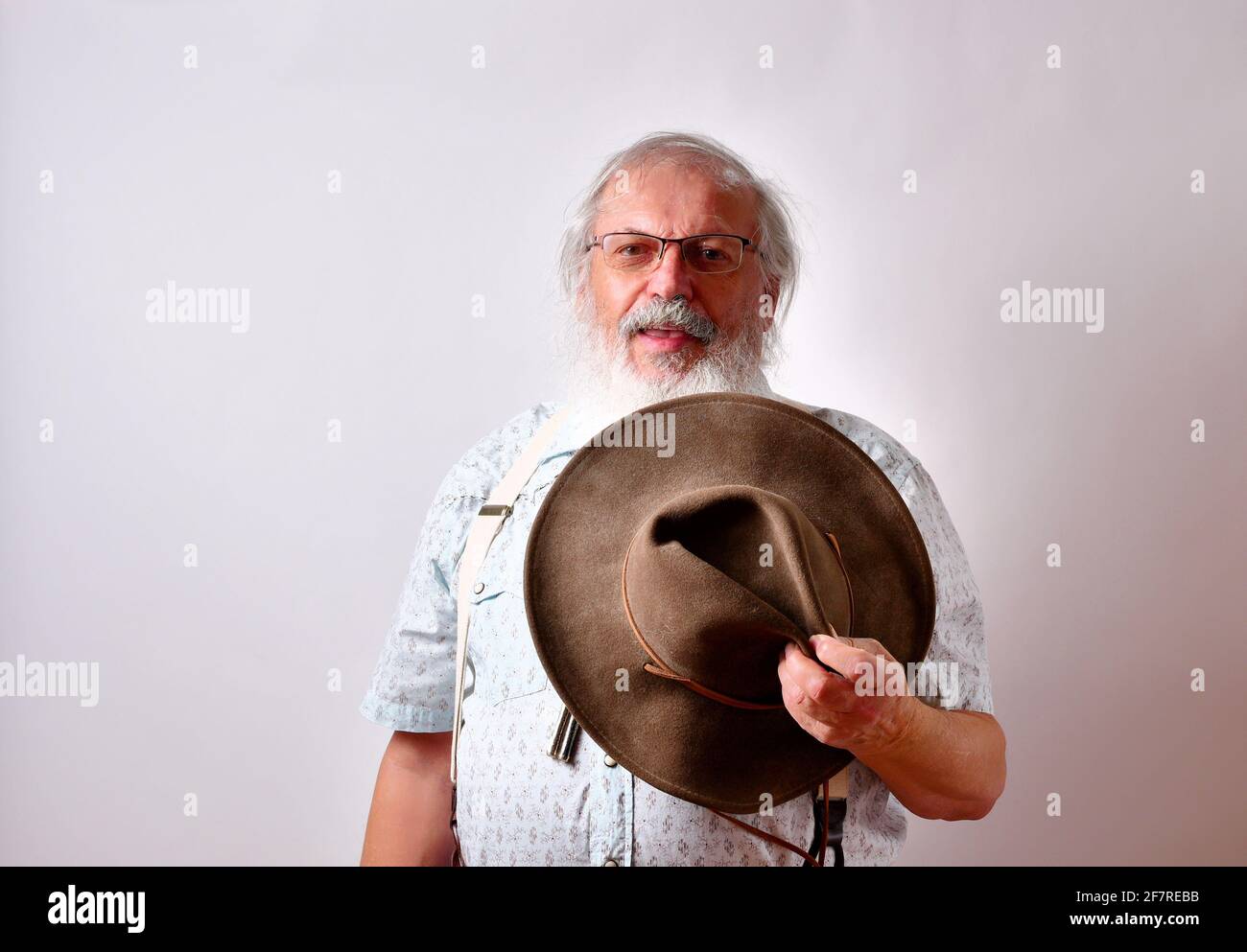 Senior Caucasian bearded male in eyeglasses showing respect by taking ...