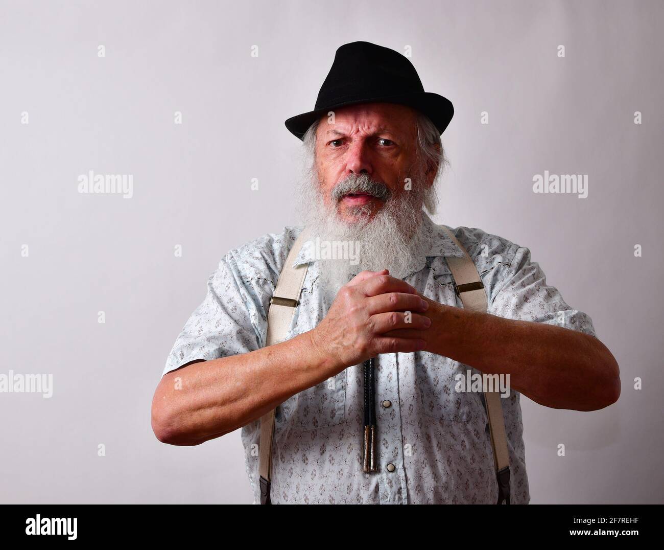Senior Caucasian bearded male with a serious expression showing ...