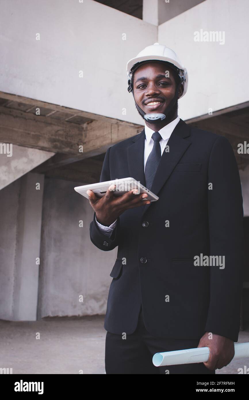 African engineer manager architect looking at construction project with ...