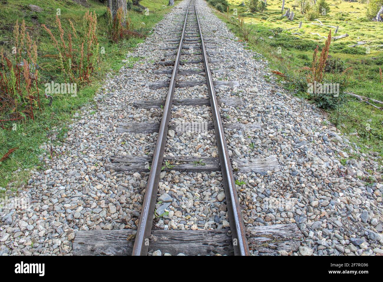 Eye view of a railway track in a rural countryside within a green grass ...