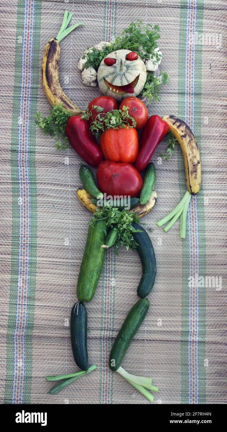 Still life with fruit and vegetables, reflecting the human body, in a ...