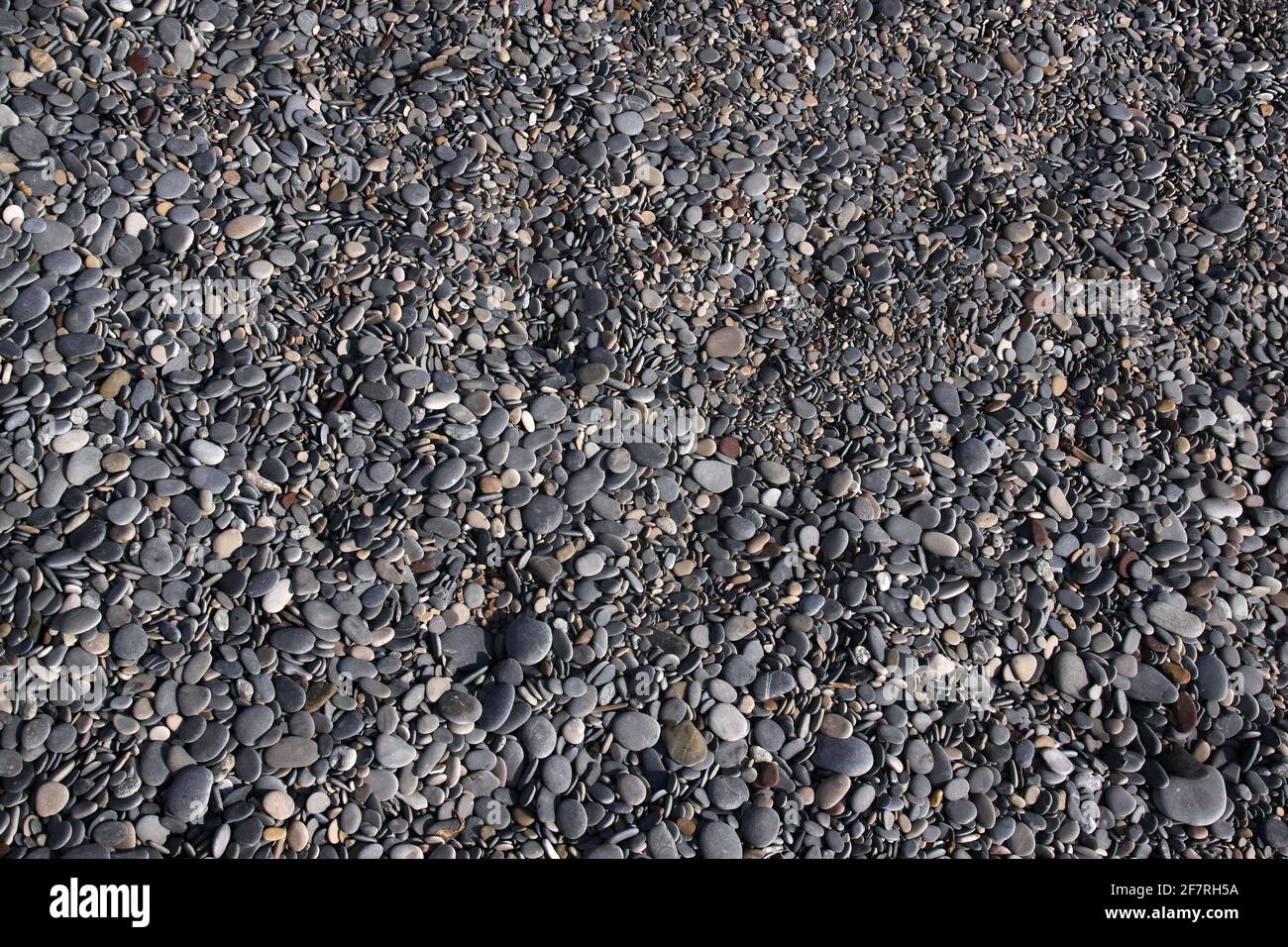 Black pebbles on the beach in Antibes. Cote d’Azur, France Stock Photo ...
