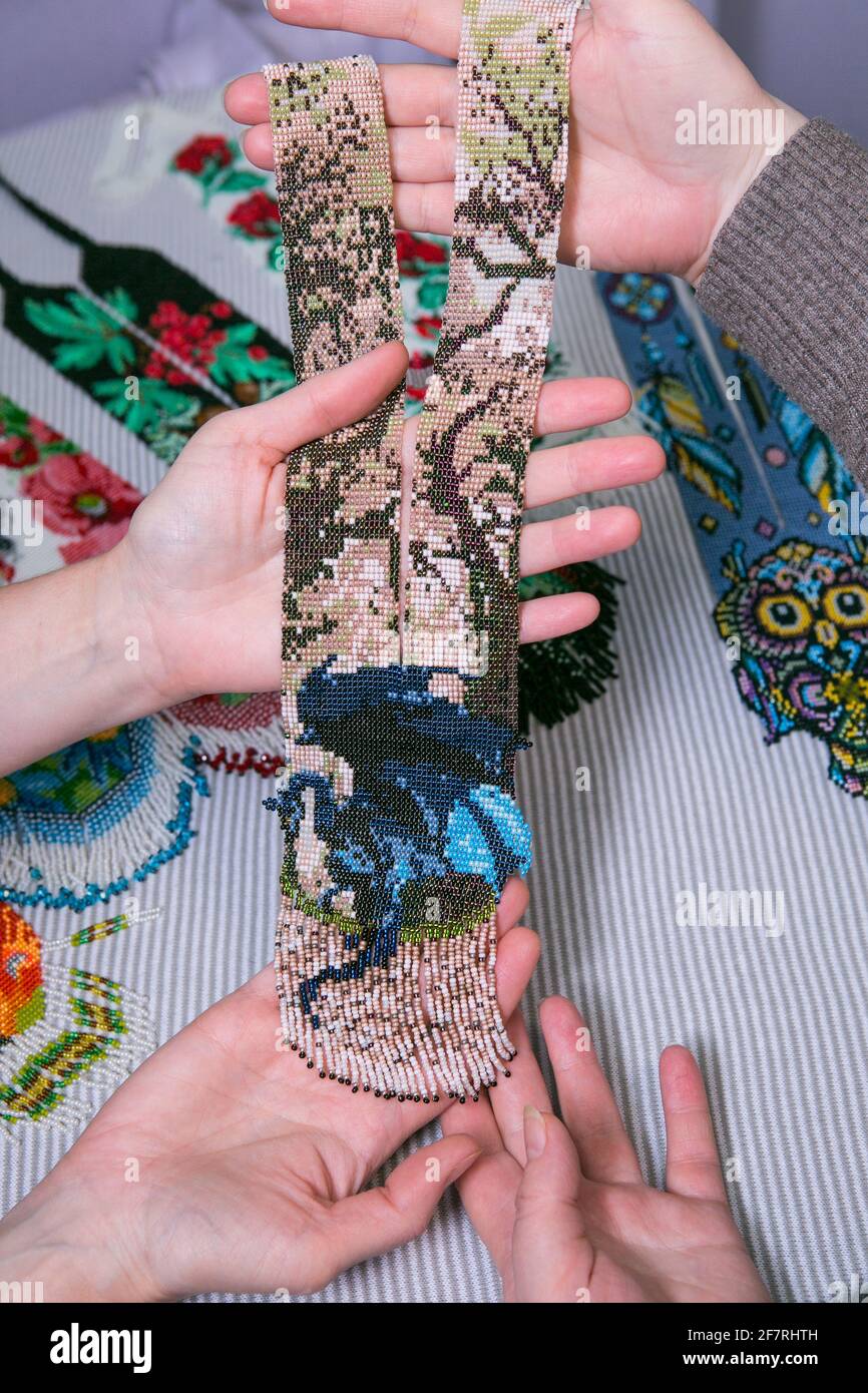 Weaving from beads. Close-up - hands of women with ready-made beads ...