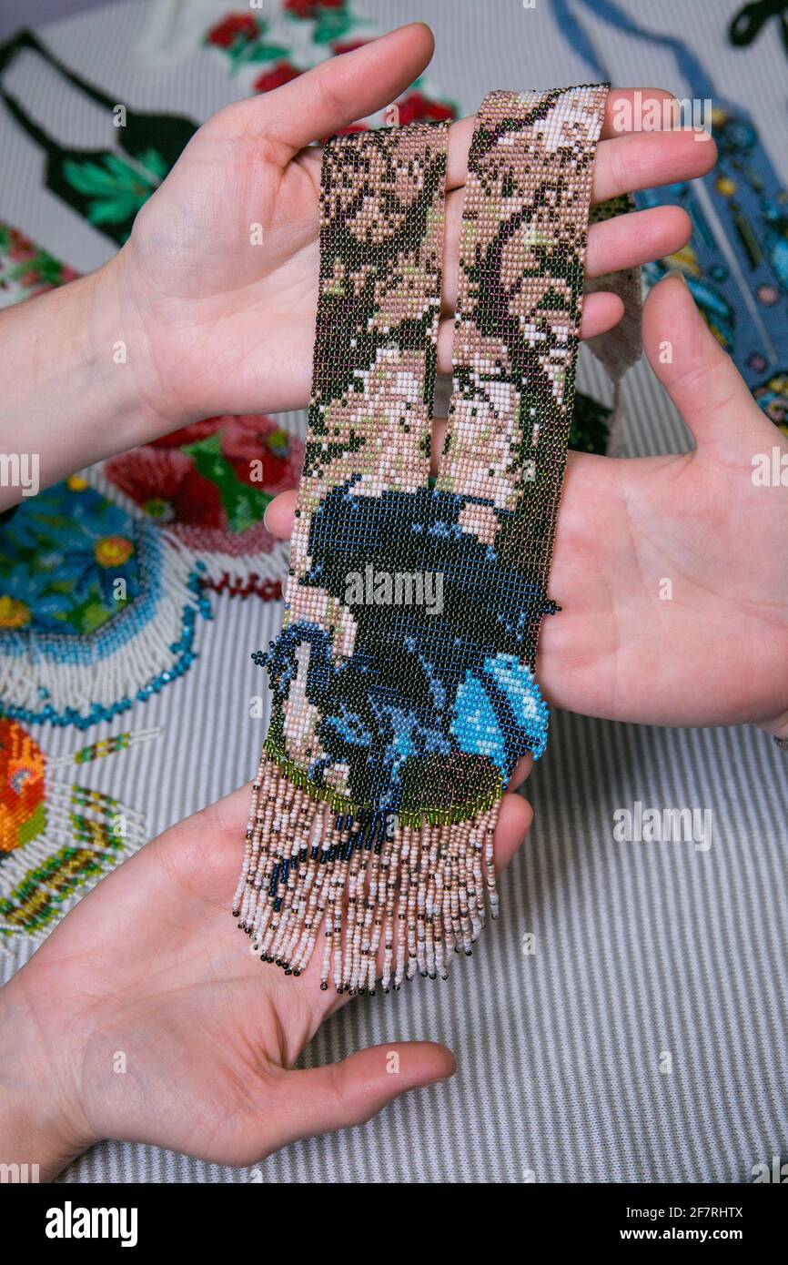 Weaving from beads. Close-up - hands of women with ready-made beads ...