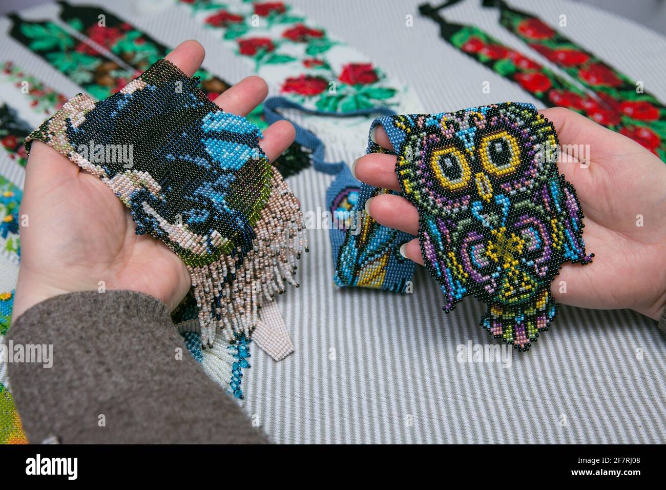Weaving from beads. Close-up - hands of women with ready-made beads ...