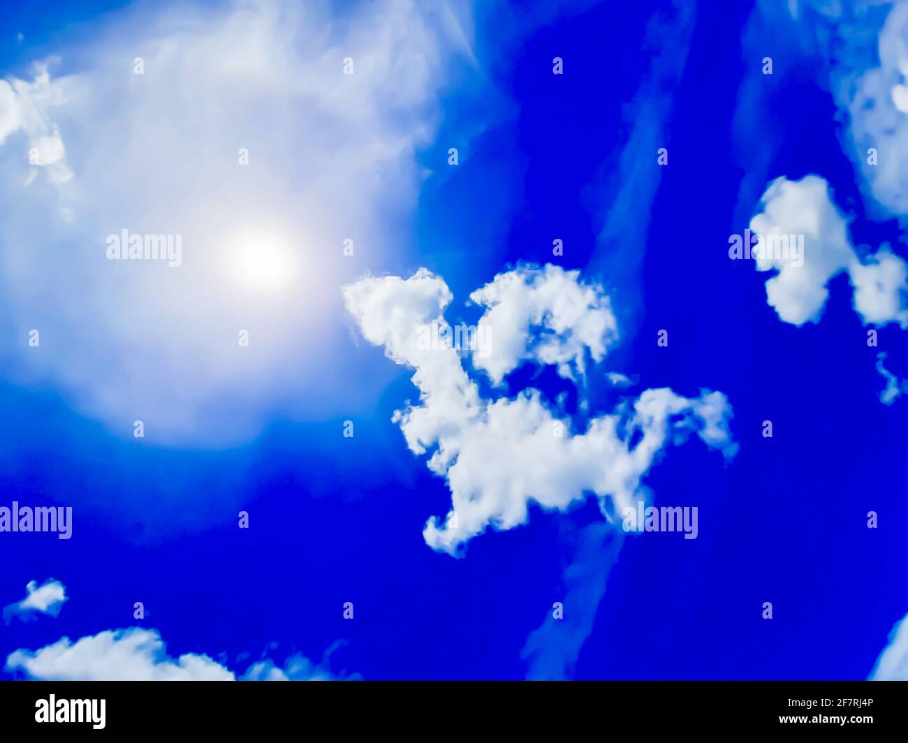 Cloudscape background with white distinctive cloud shapes and blue sky ...