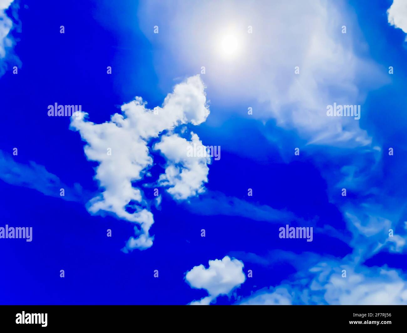 Cloudscape background with white distinctive cloud shapes and blue sky ...