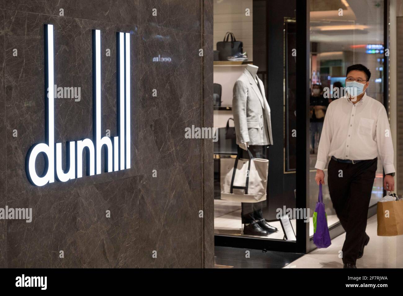 Hong Kong, China. 25th Mar, 2021. A shopper walks past the British ...