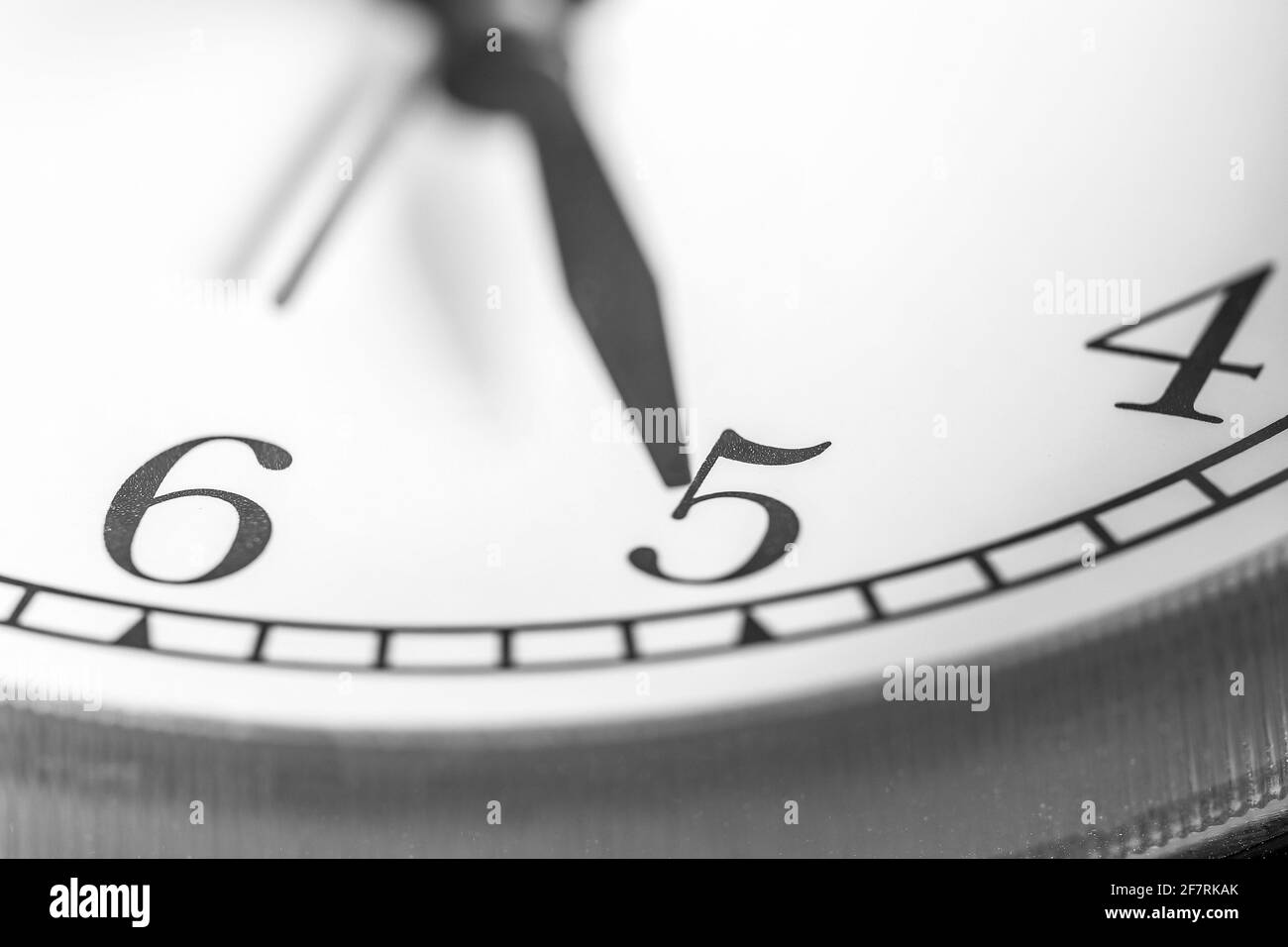 Clock hand pointing five o'clock on white clock face of Twin bell ...