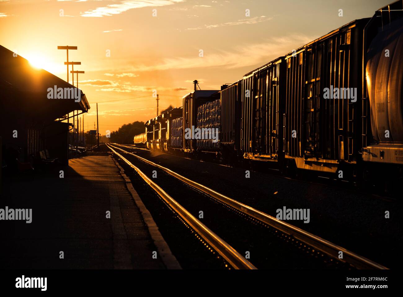 Train yard at sunset showing train at rest Stock Photo - Alamy