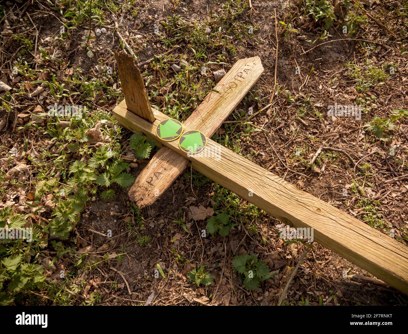A broken footpath sign in the country laying on the ground Stock Photo ...