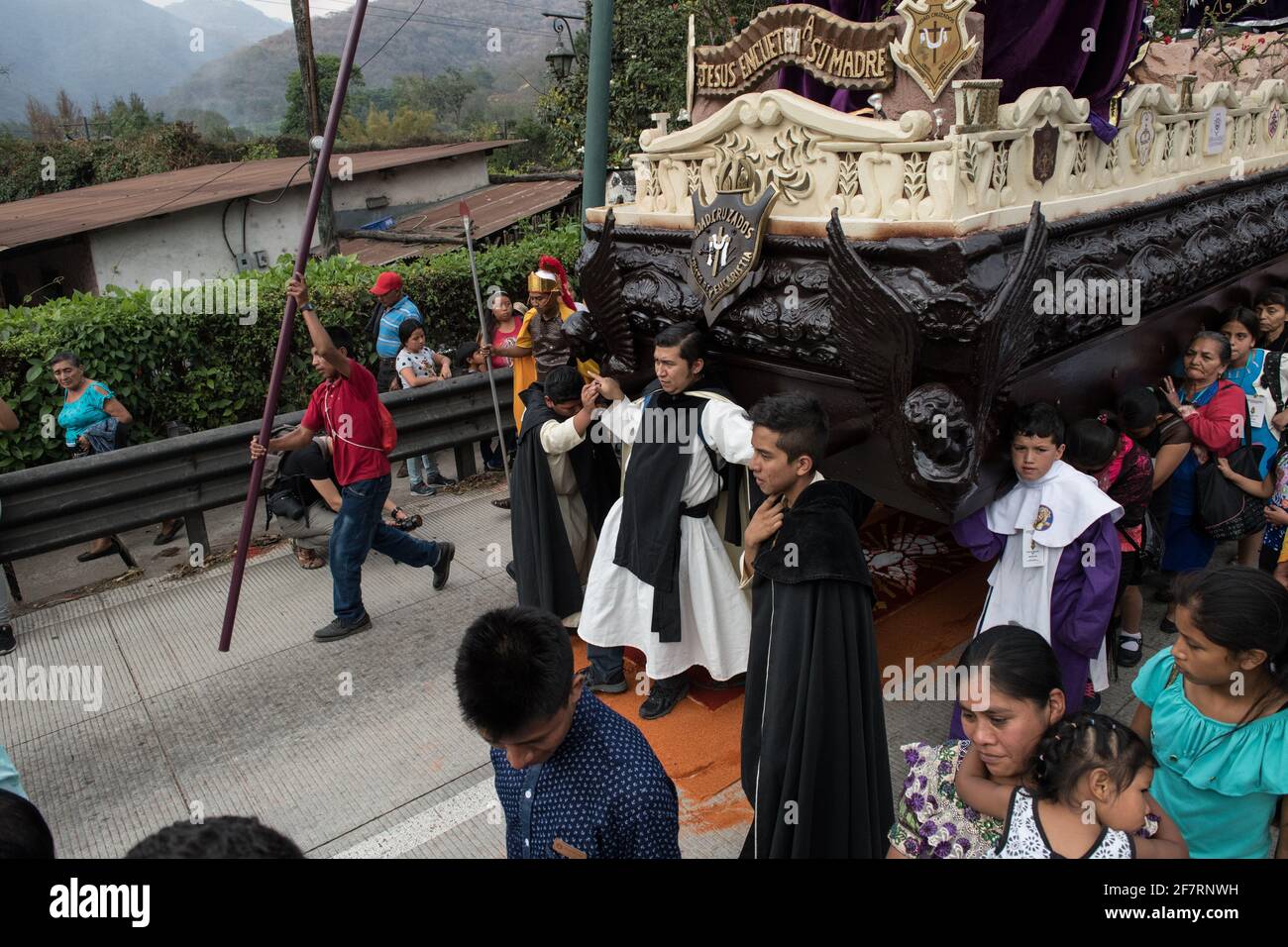 Well-dressed men in suits and women in traditional attire participate ...