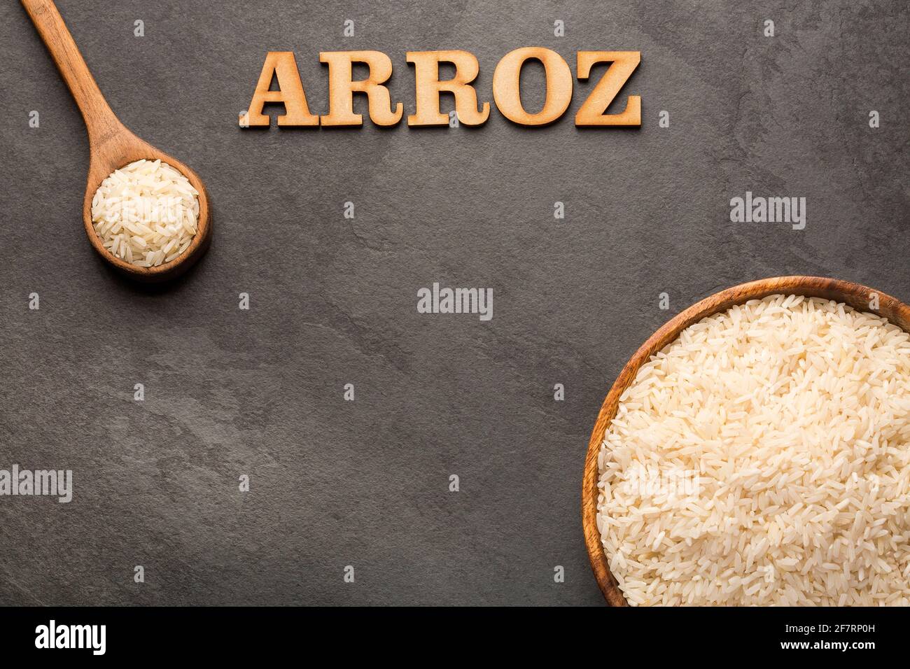 Oryza sativa - Raw white rice. Title in wooden letters Stock Photo - Alamy