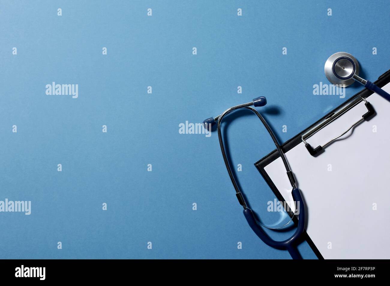 Stethoscope and tablet for recording patients on blue background Stock ...