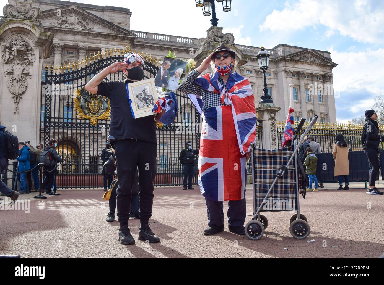 Two men pay their respect to Prince Philip outside Buckingham Palace ...