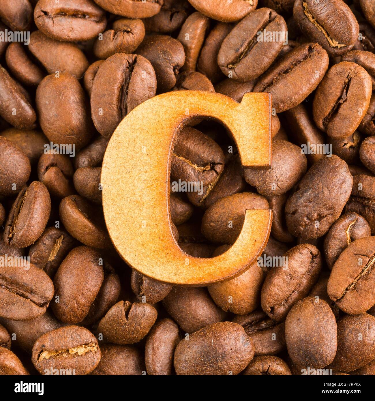 C, Letter of the alphabet on wood- background of coffee beans. Coffea ...