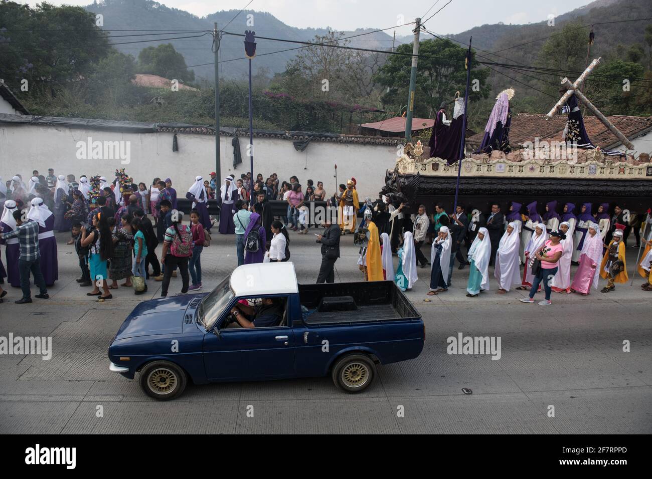 Well-dressed men in suits and women in traditional attire participate ...