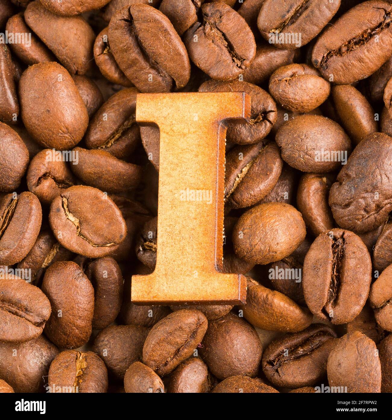 I, Letter of the alphabet on wood- background of coffee beans. Coffea ...